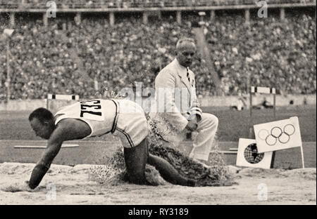 Jesse Owens long jump at the 1936 Olympics in Berlin, Germany Stock ...