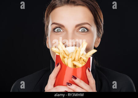woman covering face with french fries isolated on black Stock Photo - Alamy
