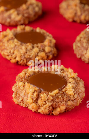 Shortbread cookies made of walnut dough with caramel on a red napkin ...