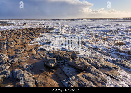 Sea foam on the shoreline at Monknash on the Glamorgan Heritage Coast ...