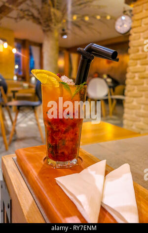 Tasty peach tea in glass on the rustic background. Selective focus ...