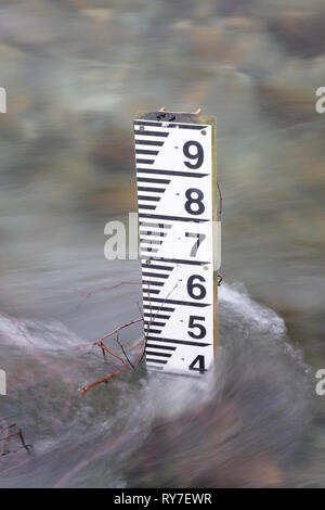 Depth stick for measuring the water level in a river Stock Photo - Alamy