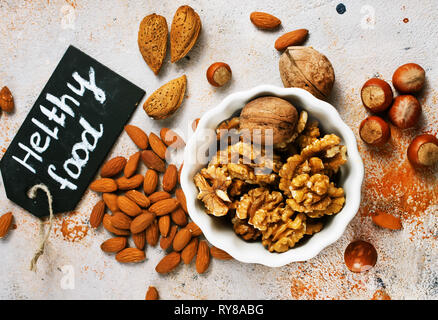 Mix nuts on beton background. Cut nuts Stock Photo - Alamy
