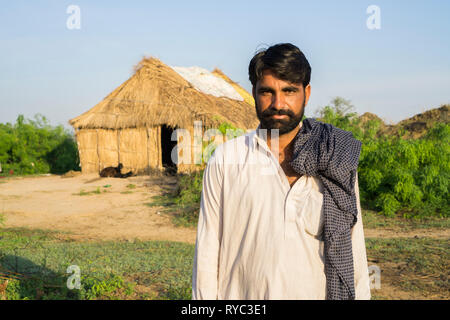 Pakistani man standing outdoors looking at camera Stock Photo - Alamy