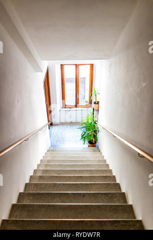 Looking down staircase at hall with wooden flooring and stained-glass ...