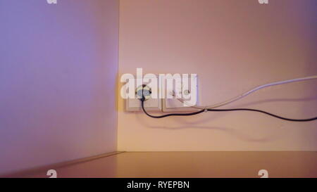 Closer look of the sockets and wires on the wall inside the bedroom ...