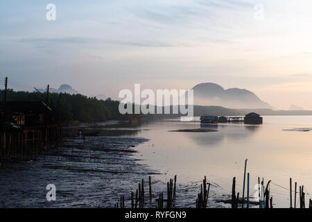 Fisherman in the sea, foggy morning over the water Stock Photo - Alamy