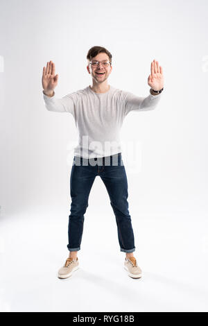 Handsome man wearing glasses amazed and surprised looking up and ...