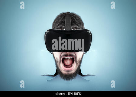 Gamer concept. Man with beard in VR glasses, light blue background. Guy ...