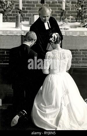 Wedding, priest and couple at the altar for marriage vows in commitment ...