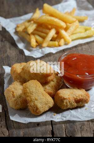 Crispy golden fries, nuggets, onion rings, and dark bread slices served ...