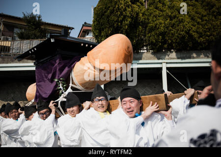 Japanese men seen carrying a replica of a phallus during the festival ...