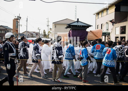Japanese men seen carrying a replica of a phallus during the festival ...