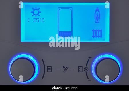 Home heating automation control unit with blue display showing working ...