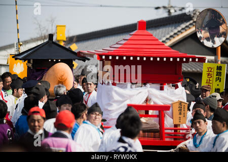 Japanese men seen carrying a replica of a phallus during the festival ...