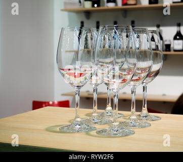 Closeup of empty wine glasses in a row on the bar table Stock Photo - Alamy