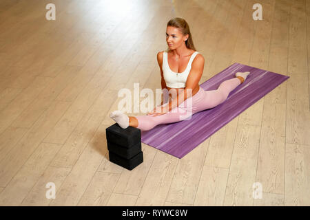 young blonde girl doing the splits in her bedroom Stock Photo - Alamy
