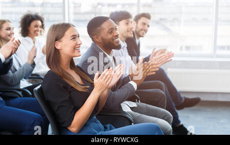 Audience clapping for female speaker in training class Stock Photo ...