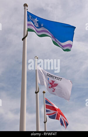 Union Jacks, Exmoor flag and Somerset flag against a light cloudy sky ...