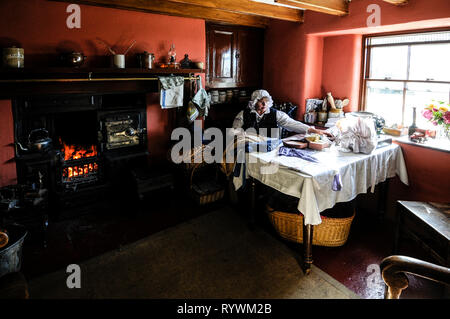 A crofter dressed in the period of the 19th century housecleaning at ...