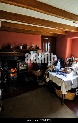 A crofter dressed in the period of the 19th century housecleaning at ...