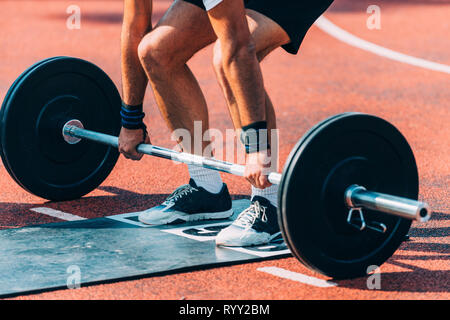 Muscular athlete lifting very heavy barbell Stock Photo - Alamy