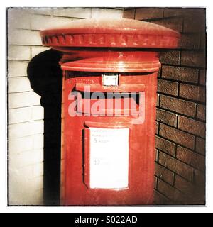 Royal Mail red post box embedded in old brick wall in UK / English ...