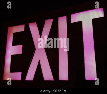 Emergency exit sign glowing in the dark Stock Photo - Alamy