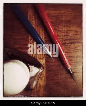 Old handwriting instruments over a wooden surface Stock Photo - Alamy