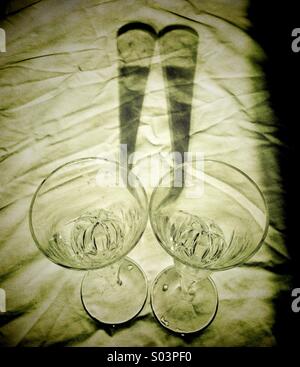 A pair of glasses casting shadows on white table. Concept: Minimalism ...