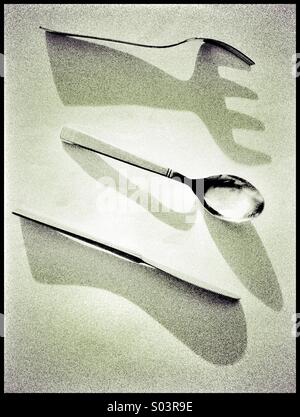 Knife fork and spoon casting shadows Stock Photo - Alamy