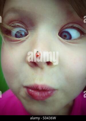 Girl with ladybug on her nose Stock Photo - Alamy