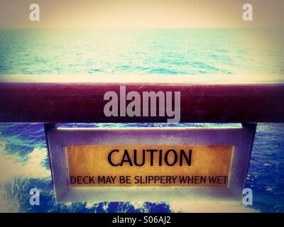 Caution warning sign slippery deck dangerous wet Stock Photo - Alamy