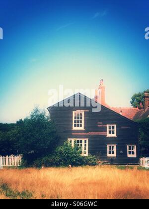 House in field Stock Photo - Alamy
