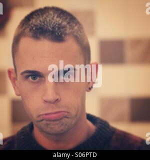 Man making sad face Stock Photo - Alamy
