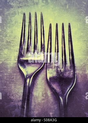 Two forks on a dinner table in a restaurant Stock Photo - Alamy
