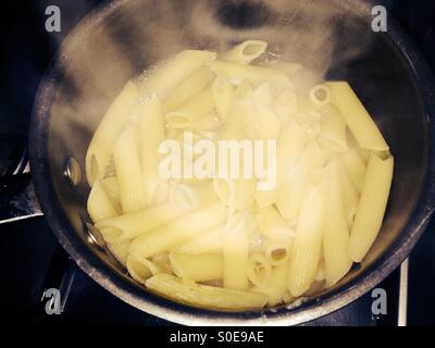 penne pasta in saucepan with boiling water, wide photo Stock Photo - Alamy