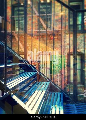 Fire escape through window SoHo NYC Stock Photo - Alamy