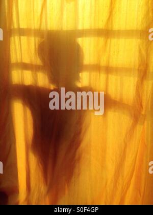 Boy is behind the curtain Stock Photo - Alamy