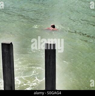 Bald man swimming Stock Photo - Alamy