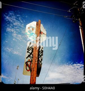 Graffiti-covered stop sign Stock Photo - Alamy