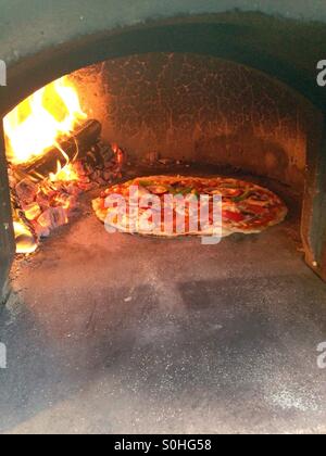 Wood fired pizza oven with hot fire Stock Photo - Alamy