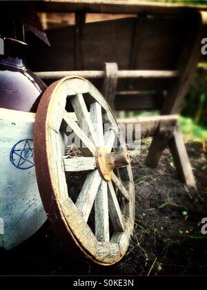 A jug and a wagon wheel Stock Photo - Alamy