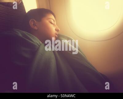 Children sleeping on airplane Stock Photo - Alamy