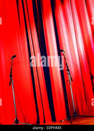 microphone on stage with red curtain background Stock Photo - Alamy