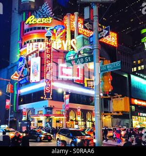 Times Square at night with bright billboards, illuminated city lights ...