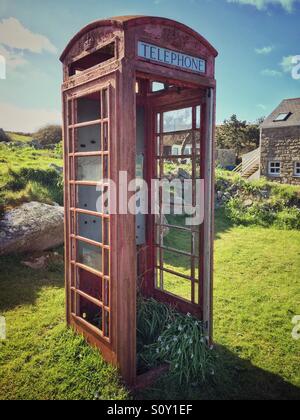 Overgrown red telephone box Stock Photo - Alamy