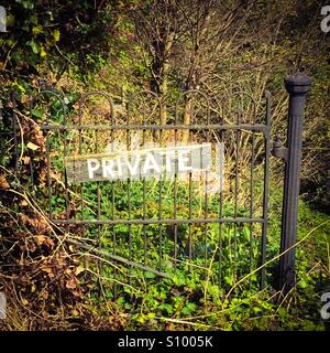 old metal sign with keep gate closed message fixed to a chain link ...