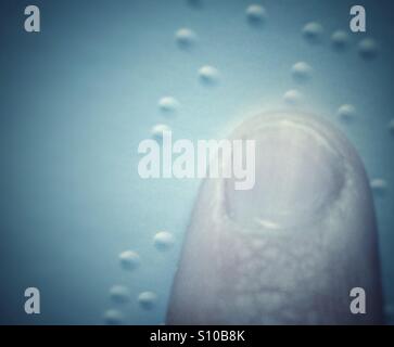 Reading braile raised writing on a medicine prescription packaging ...