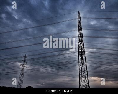 Overhead electric power cables running from a central wooden pole to a ...